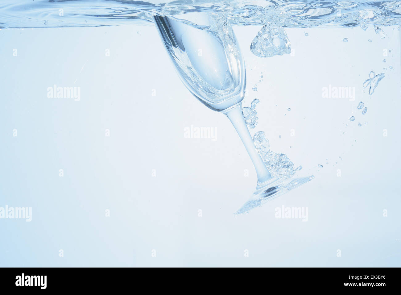 Champagne glass falling into water Stock Photo - Alamy