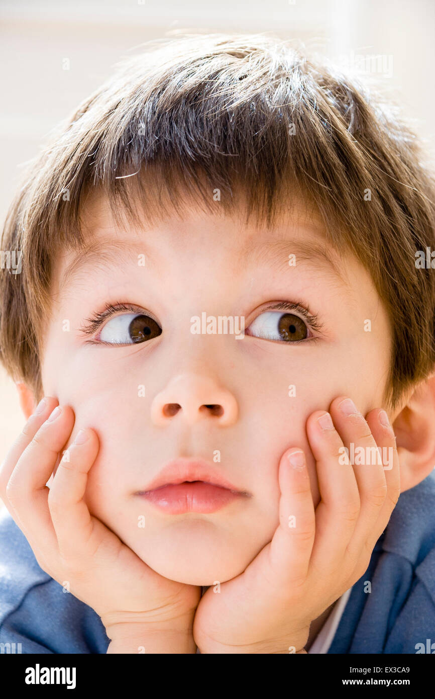 Caucasian child, boy, 5-6 year old, facing viewer while laying down on ...