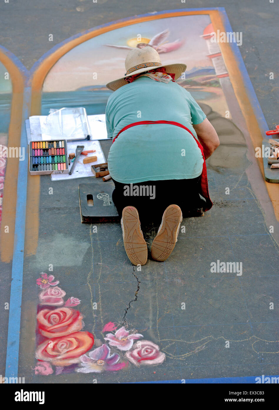 A woman artist painting with chalk at the "Old Santa Barbara Mission ...