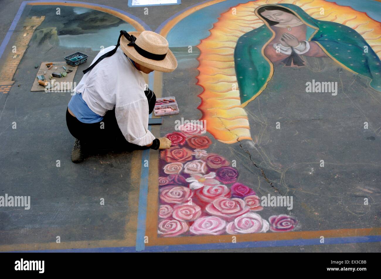 A woman artist painting with chalk at the "Old Santa Barbara Mission ...