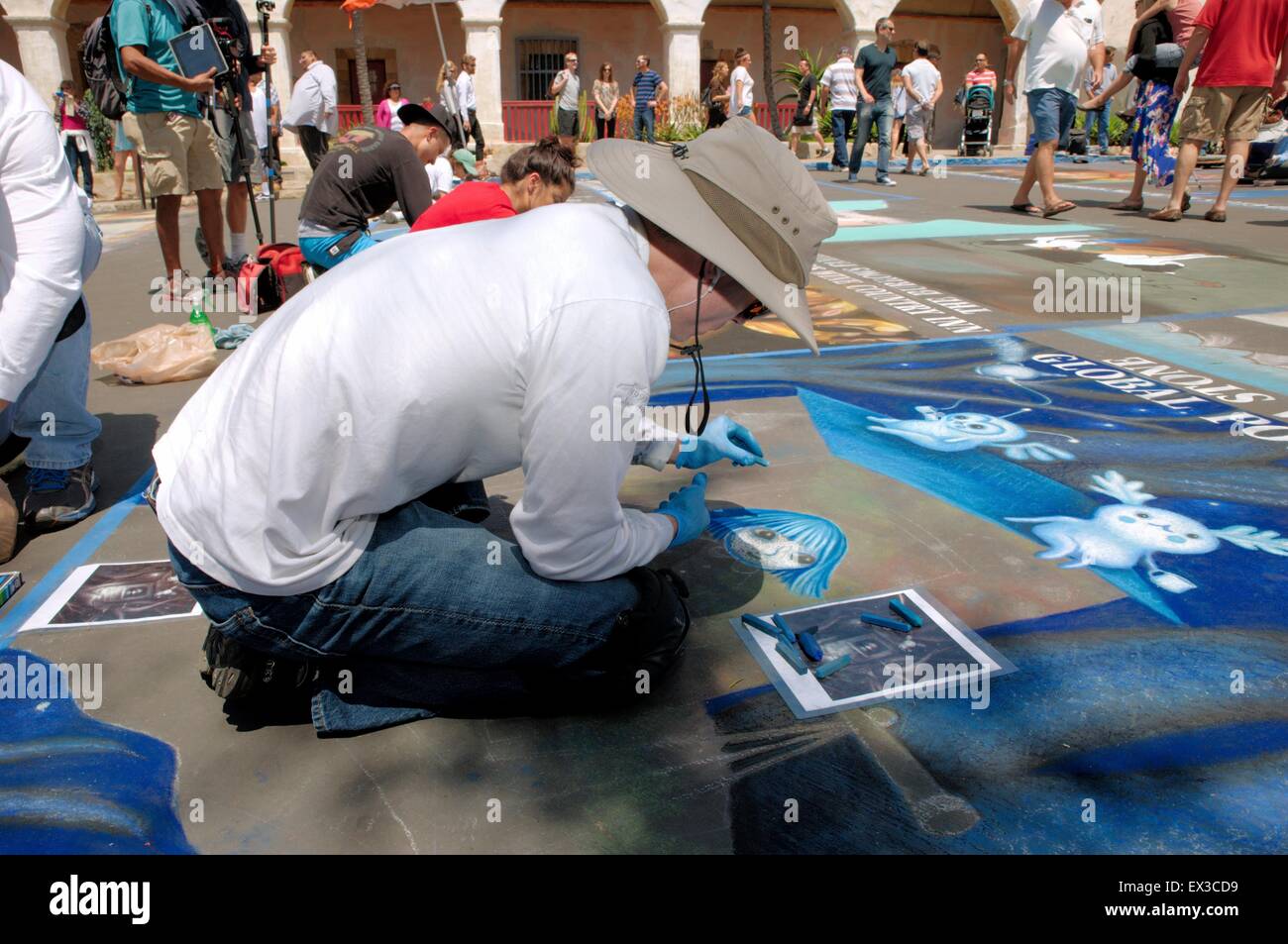 An adult male artist painting with chalk at the "Old Santa Barbara ...