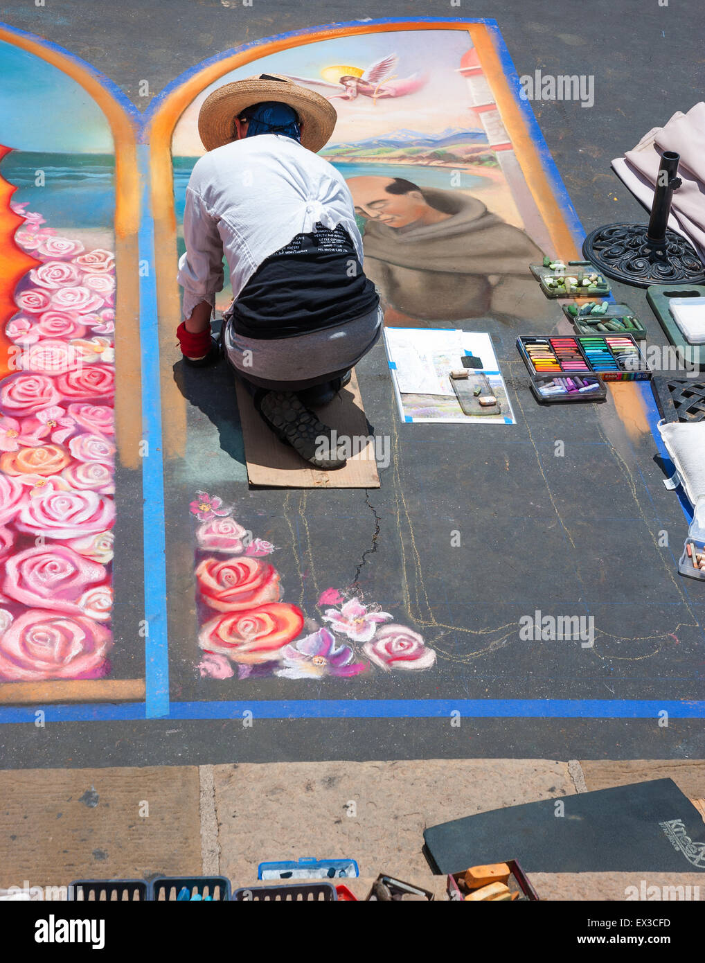 A woman artist painting with chalk at the "Old Santa Barbara Mission ...