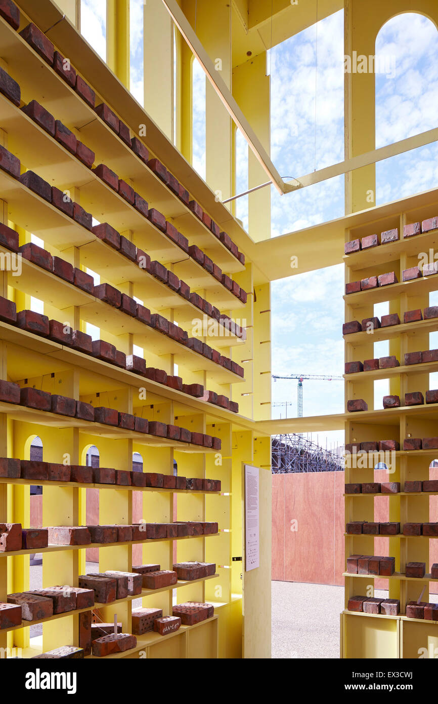 Interior of the pavilion with shelving showing reclaimed bricks, arches ...