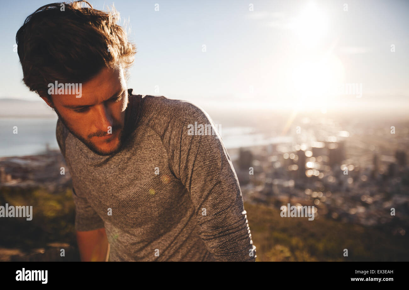 Close up shot of young man resting after running workout. Runner ...