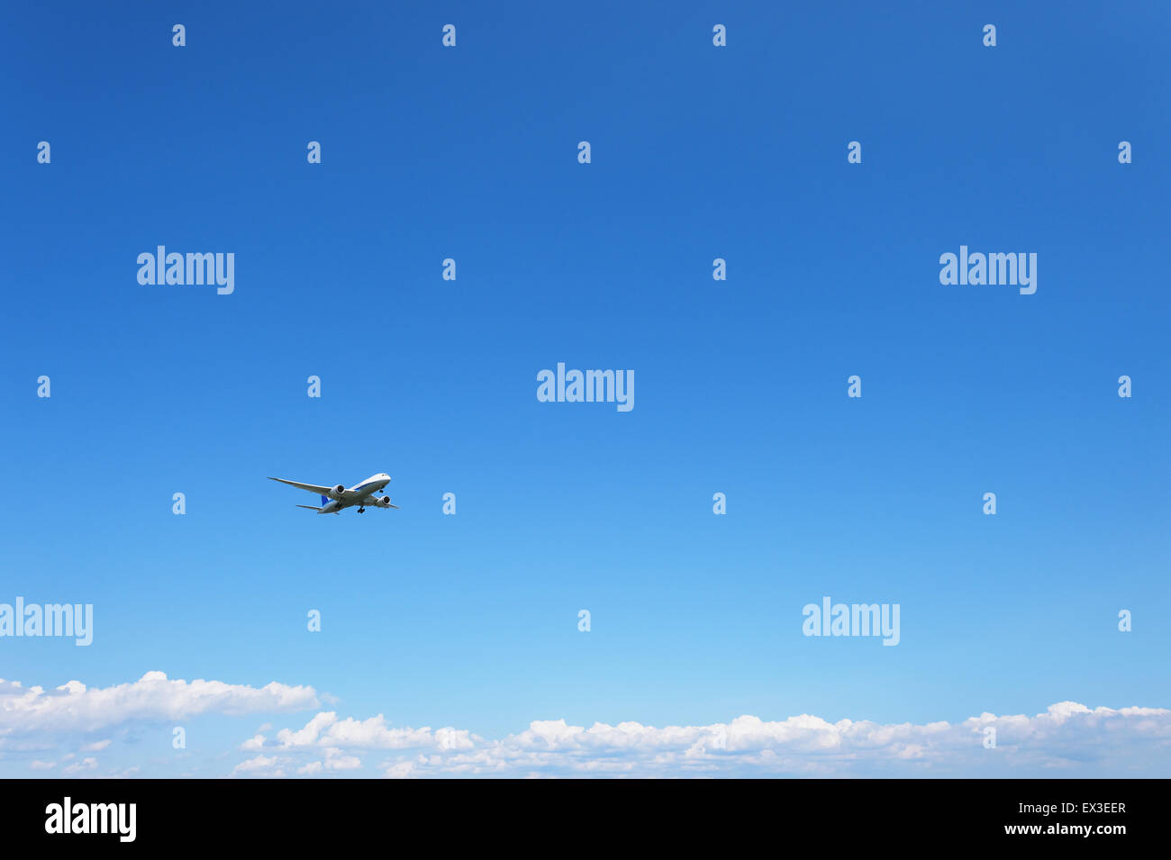 Airplane flying in the sky Stock Photo - Alamy