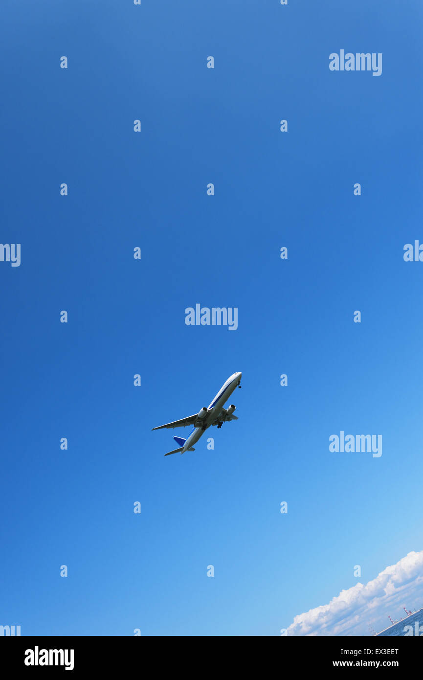 Airplane flying in the sky Stock Photo - Alamy