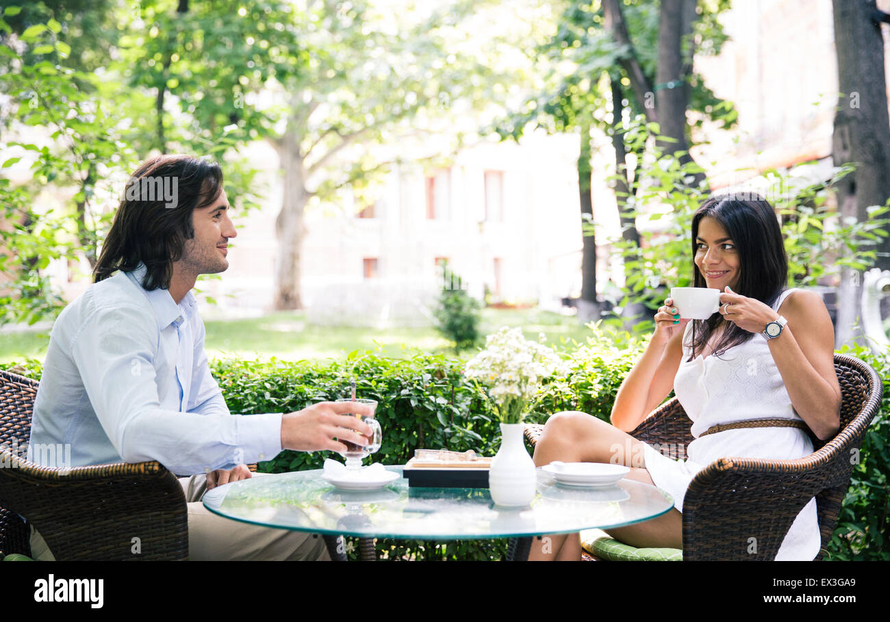 Happy beautiful couple drinking coffee and having romantic time in ...