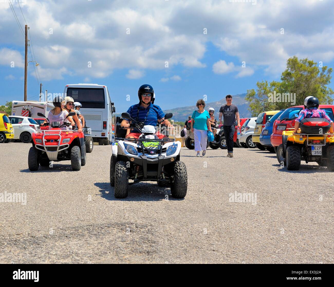 People riding an ATV quad rental bike in Akrotiri Santorini Greece ...