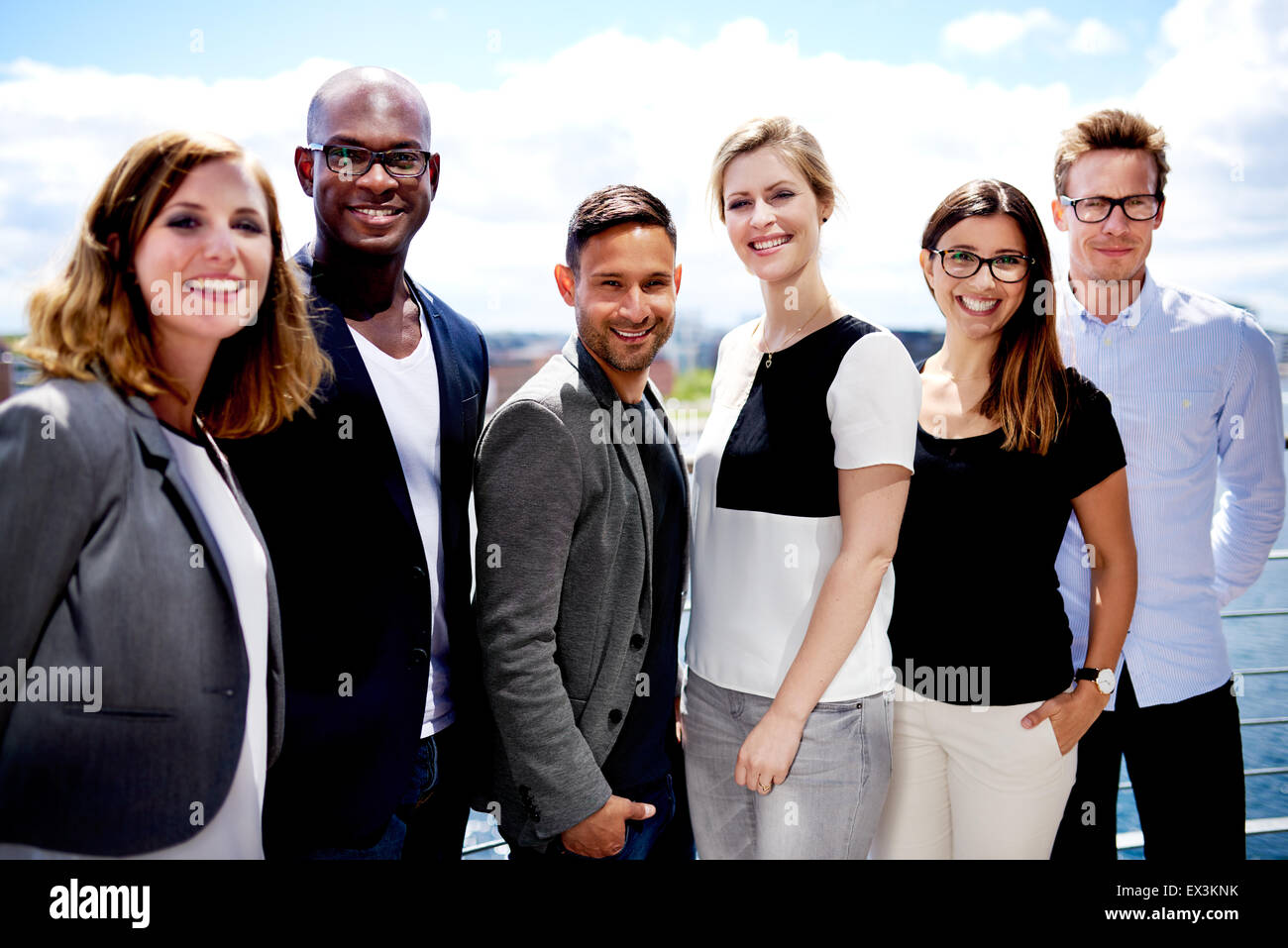 Group of executives smiling and posing outside for picture Stock Photo ...