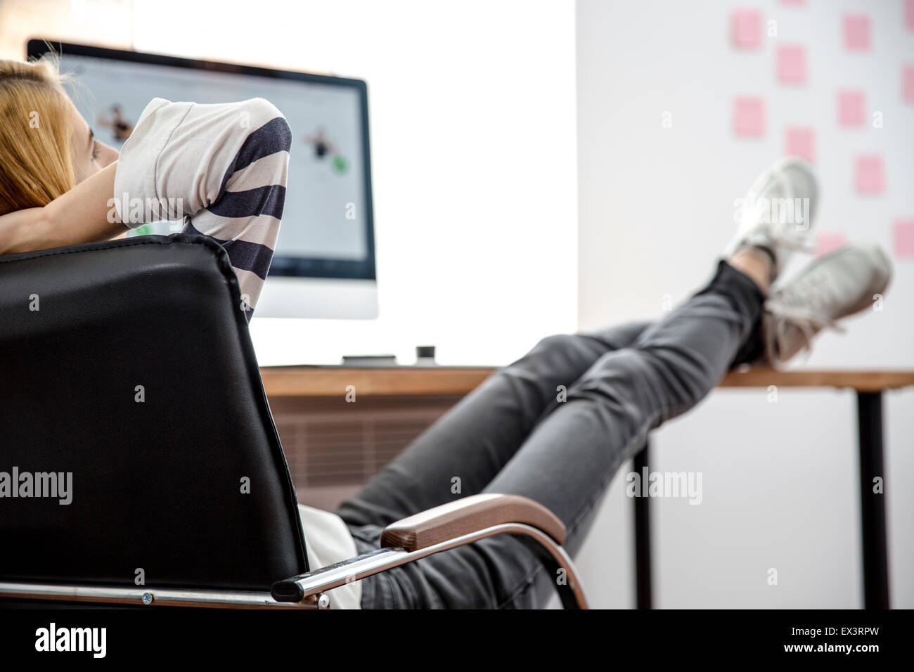 Young girl resting at the table in office Stock Photo - Alamy