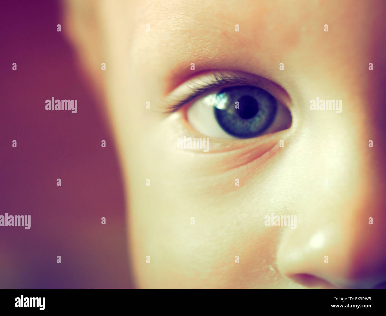 July 5, 2015 - Blue eye of little boy, half face close-up. Vintage ...