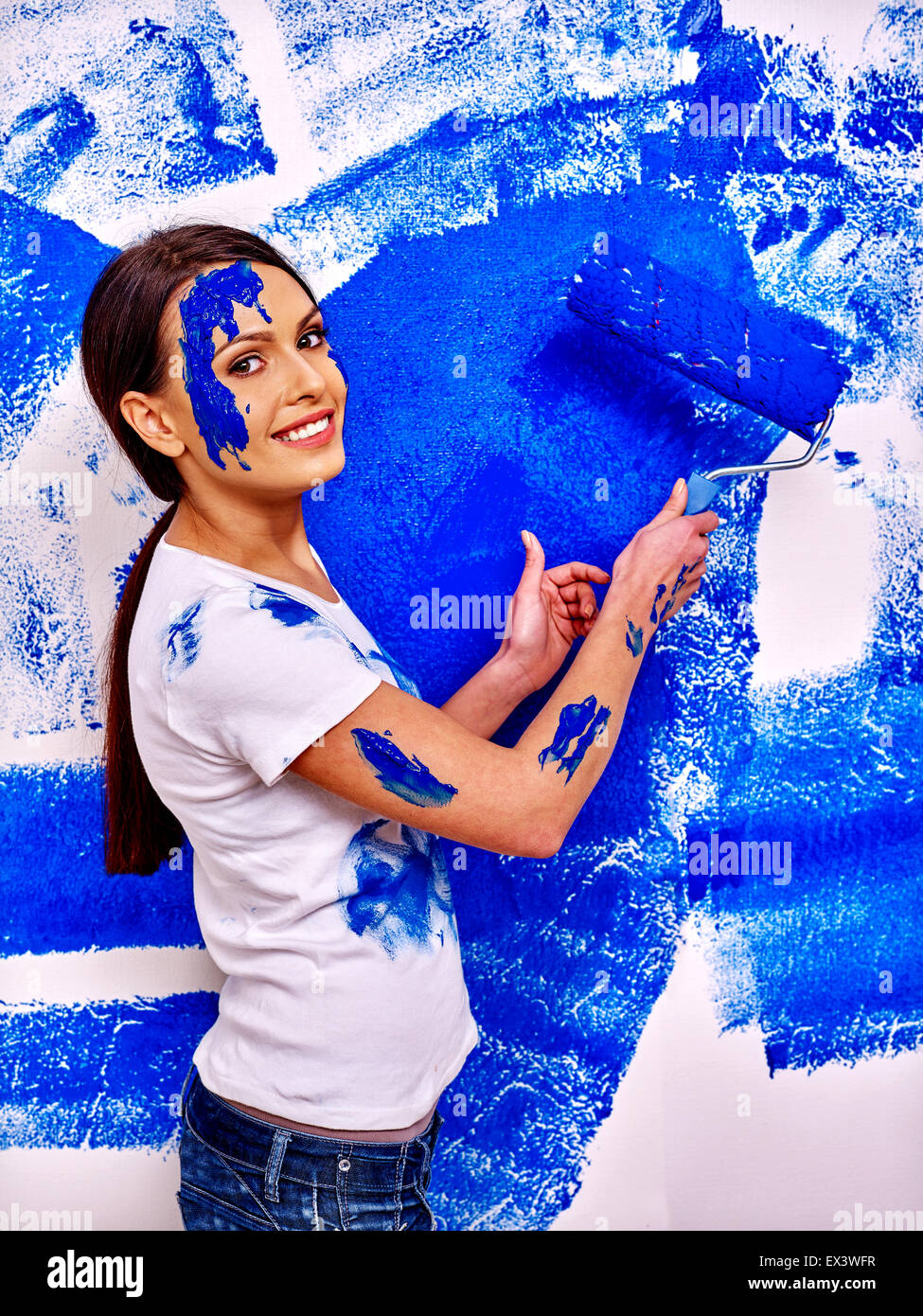 Woman paint wall at home Stock Photo - Alamy