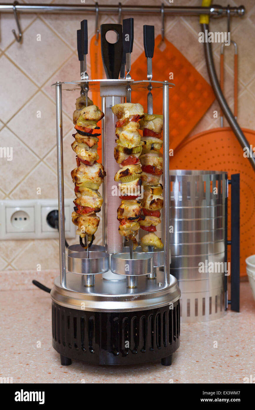 Cooking meat in a homemade electric barbeque Stock Photo - Alamy