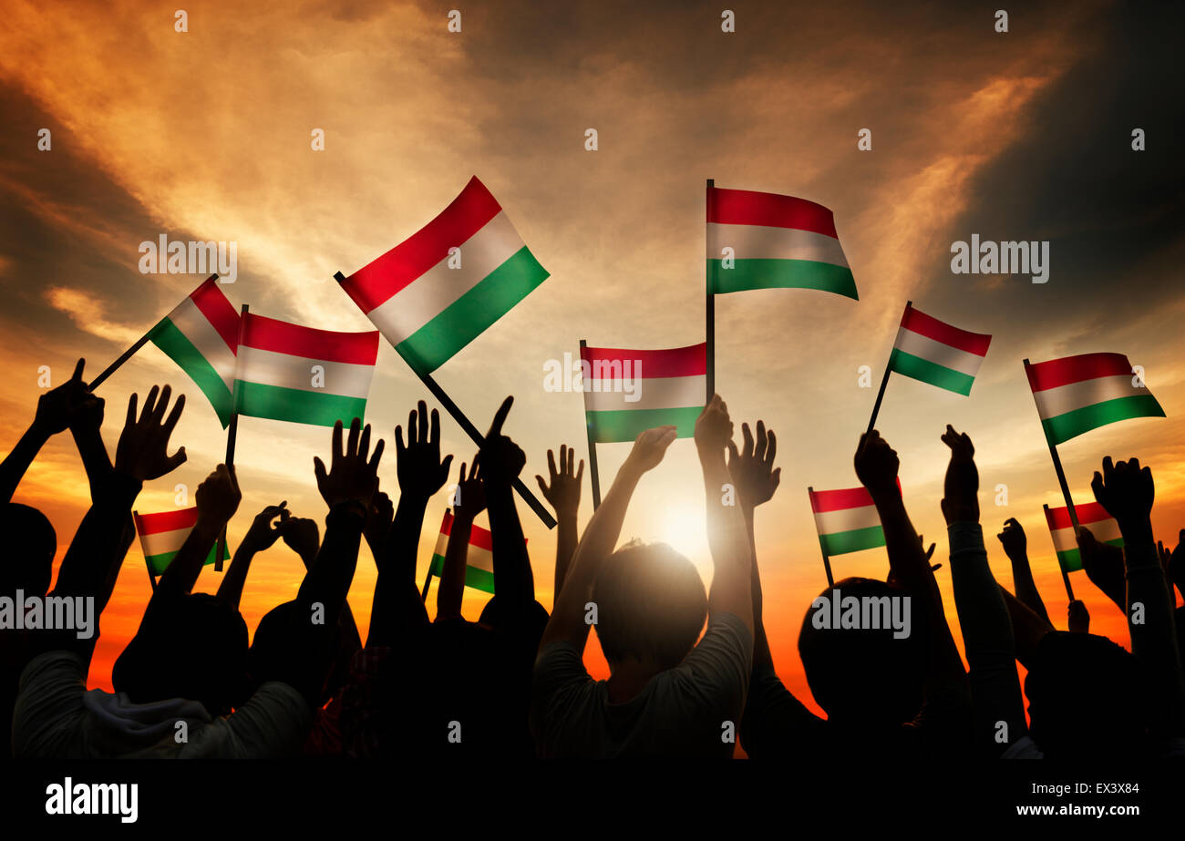 Silhouettes of People Holding the Flag of Hungary Stock Photo - Alamy