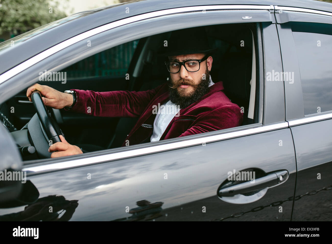 Man with beard driving a car Stock Photo - Alamy