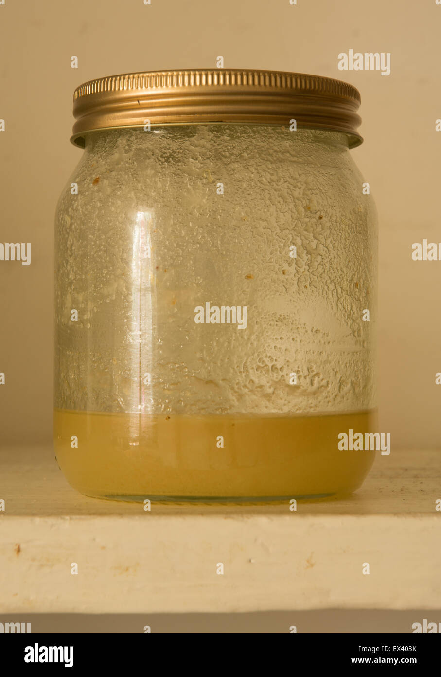 half-eaten jar of honey on a shelf Stock Photo - Alamy