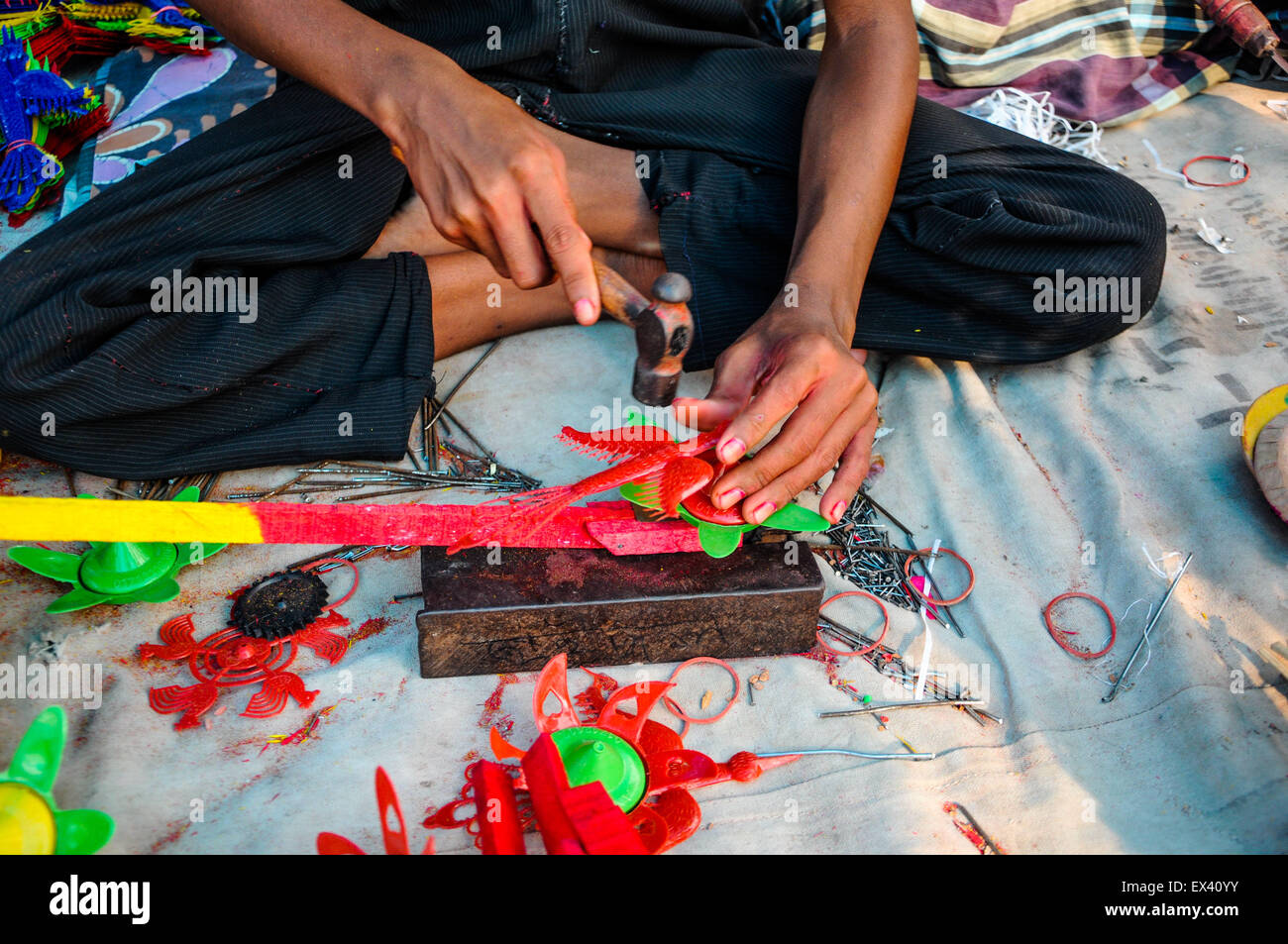 Dhaka, Bangladesh. 6th July, 2015. A child works in a toy making ...