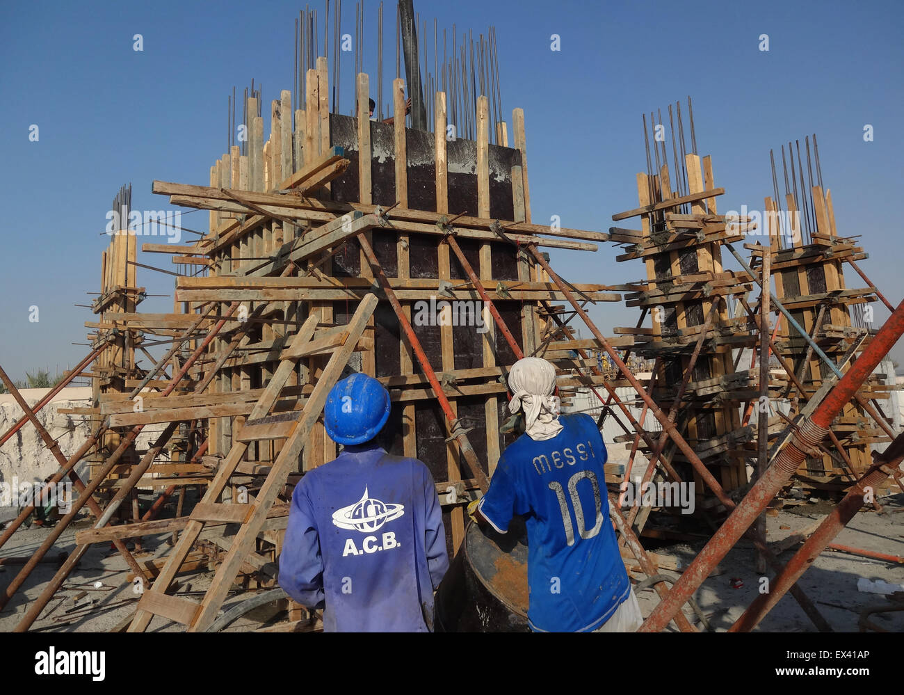 A Messy fan Construction Labor at work fixing shuttering for columns ...