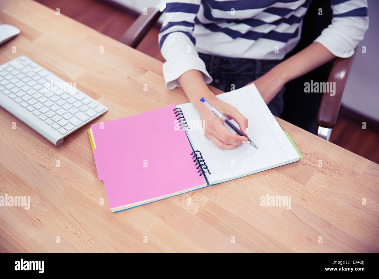 Closeup portrait of a casual woman writing notes in office Stock Photo ...