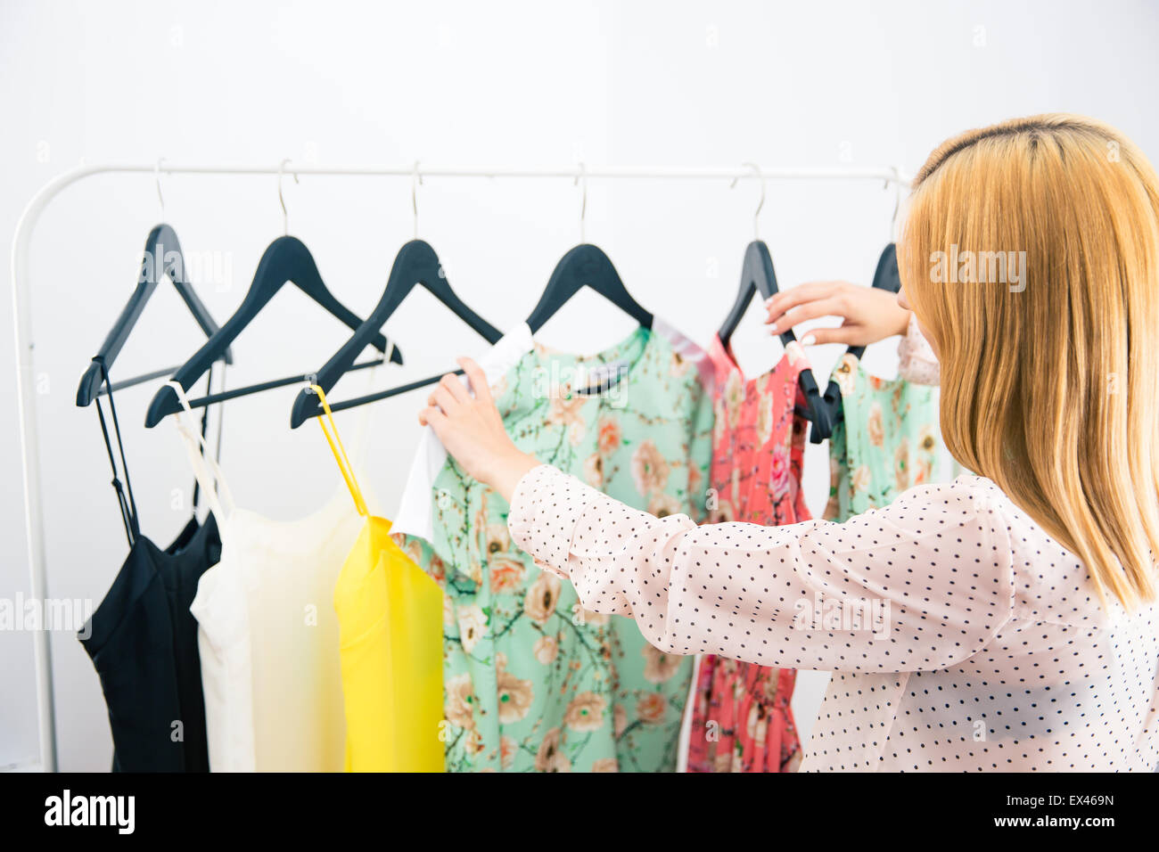 Young woman choosing cloth Stock Photo - Alamy