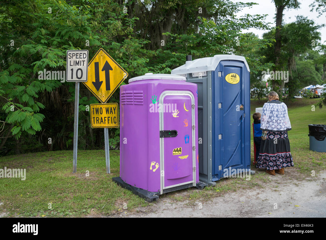 outhouses at a festival, one for adults and one for children, including ...