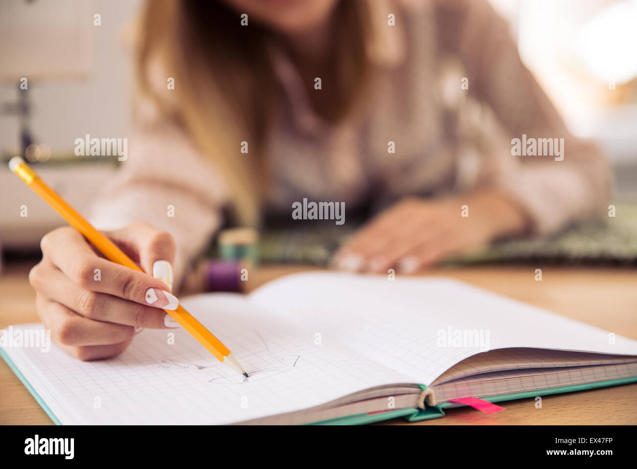 Closeup portrait of female designer writing notes in workshop Stock ...