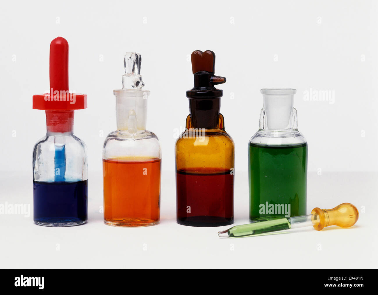 Four bottles of different coloured liquids for chemical stain tests ...
