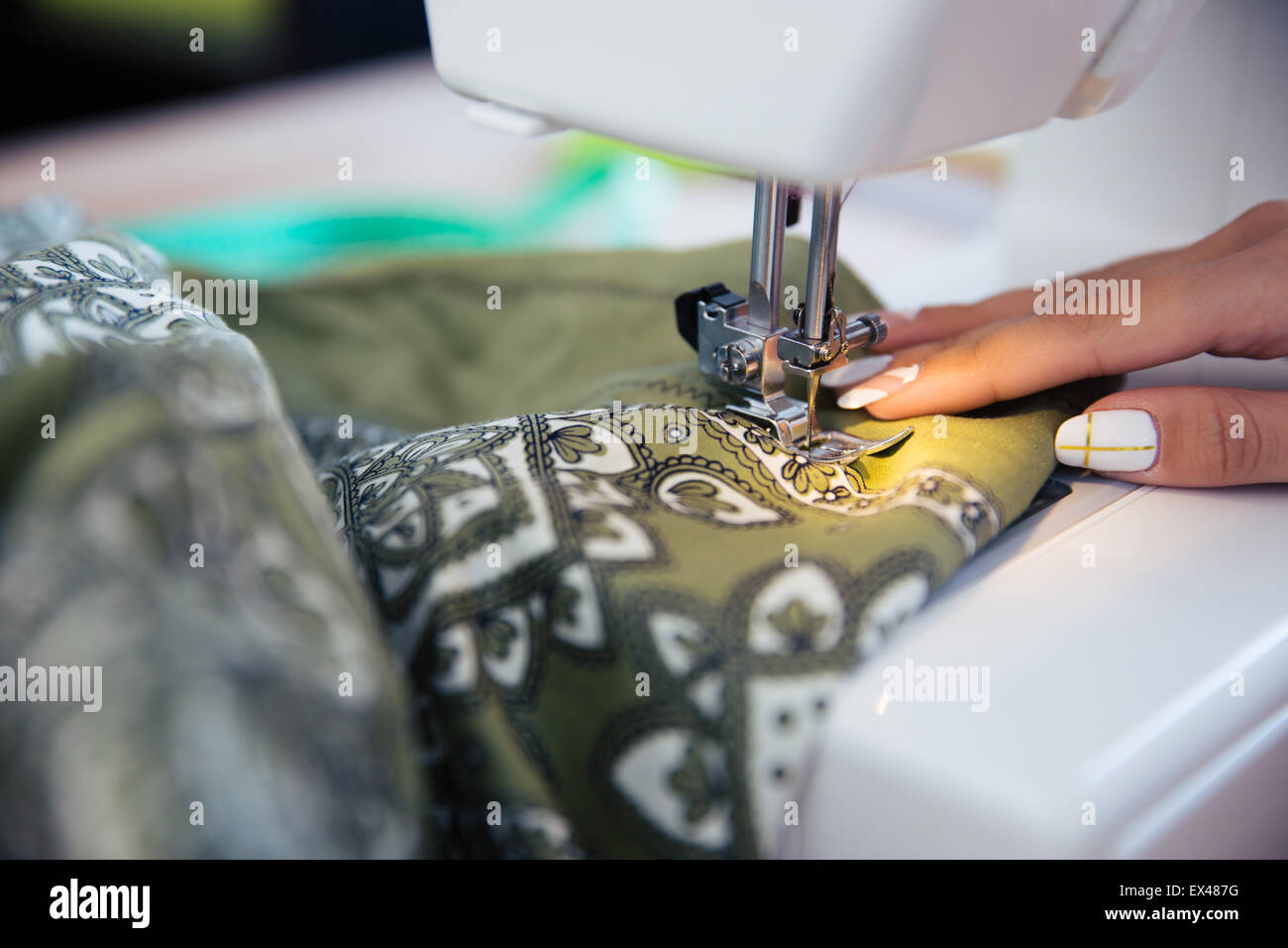 Closeup portrait of female hand with sewing machine Stock Photo - Alamy