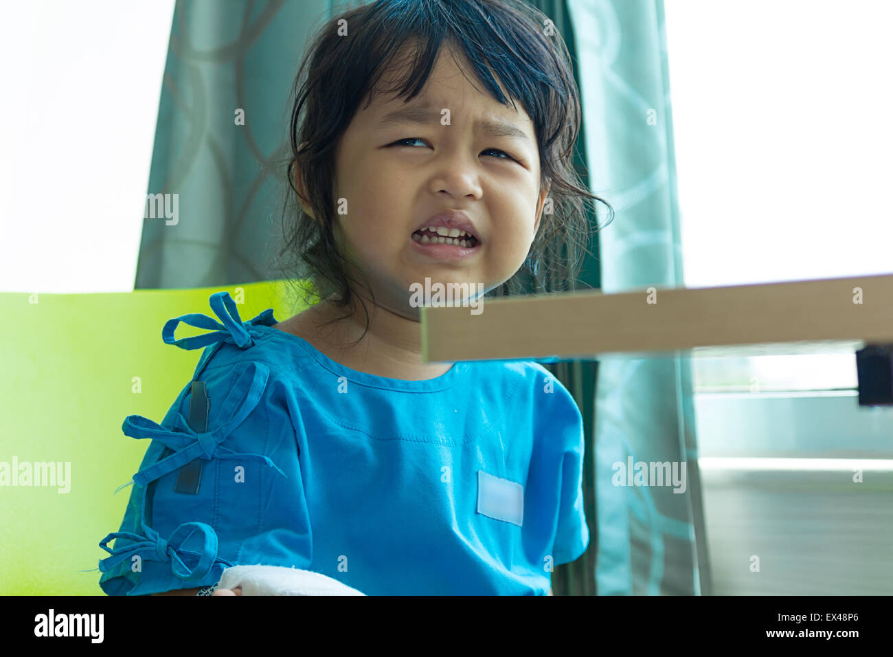 Illness asian kids crying, sit on a chair in hospital, saline ...