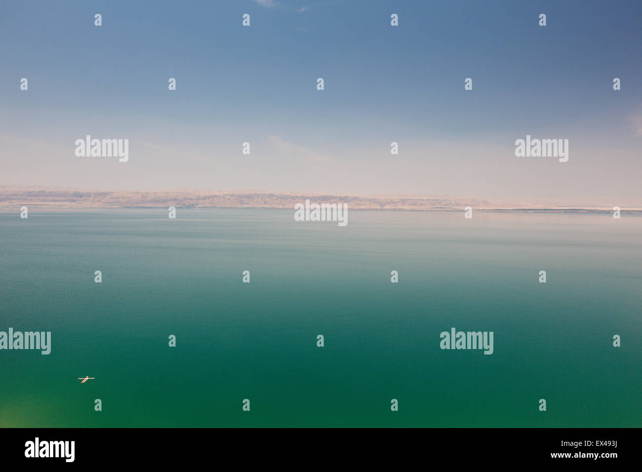 The Dead Sea, Jordan. Single tourist floating with his arms ...