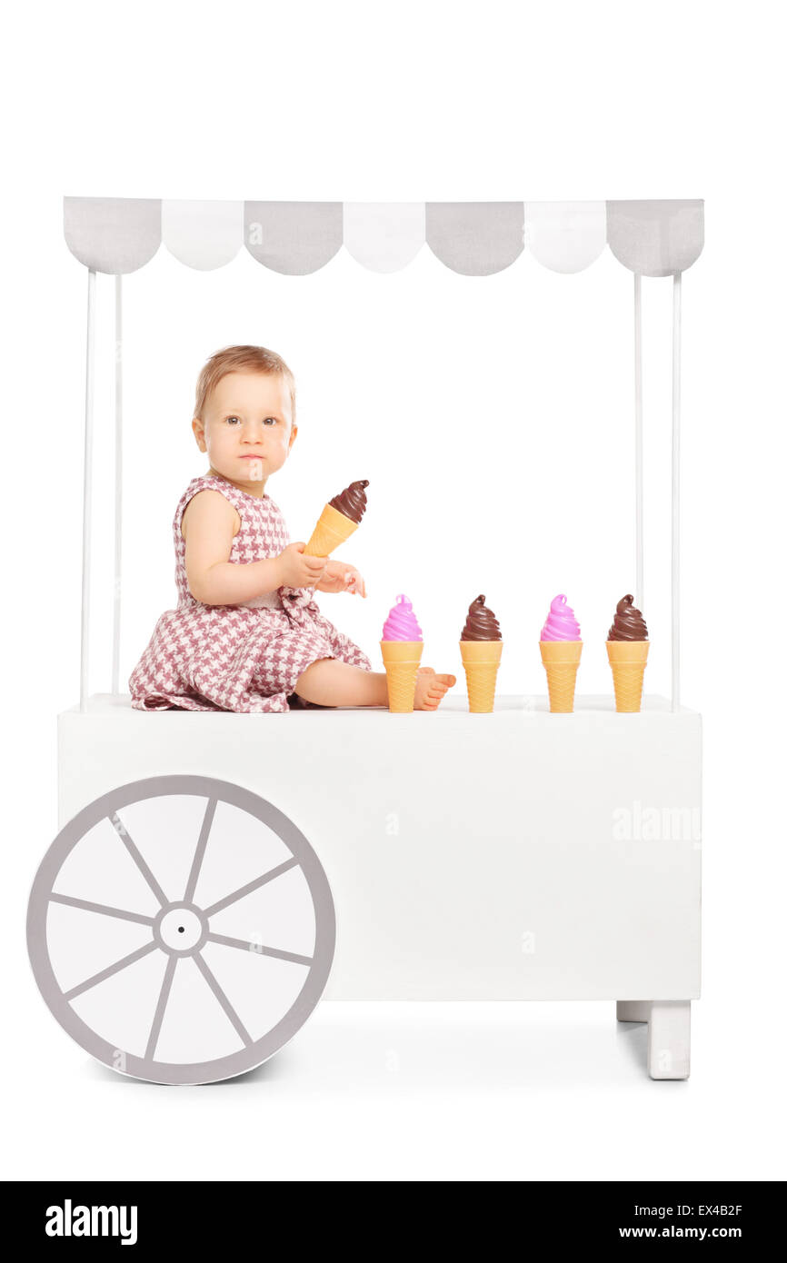 Cute little baby girl holding an ice cream cone seated on an ice cream ...