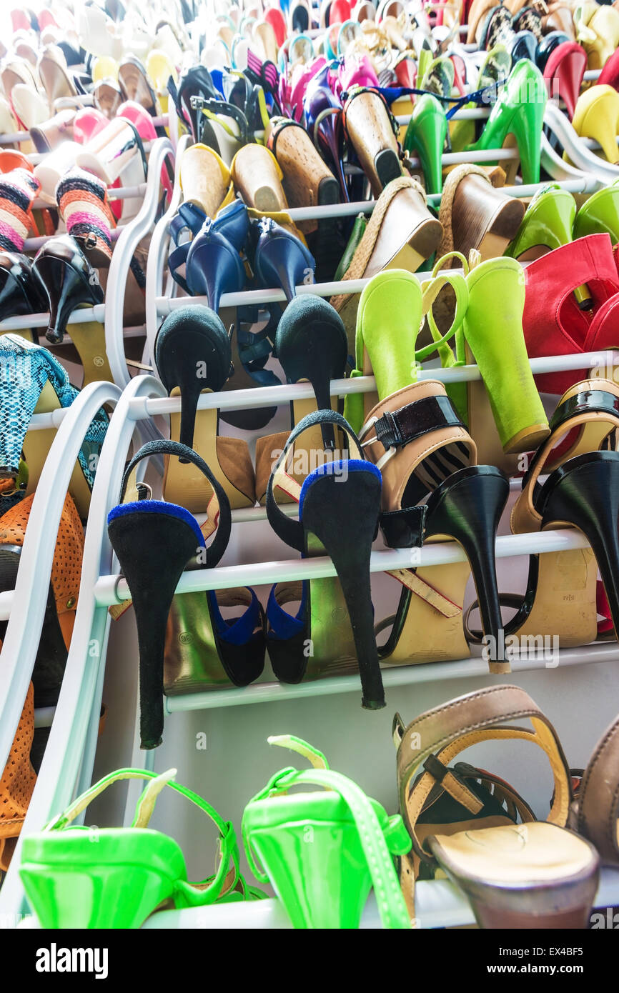 Rack with multicolored female shoes on heels Stock Photo - Alamy