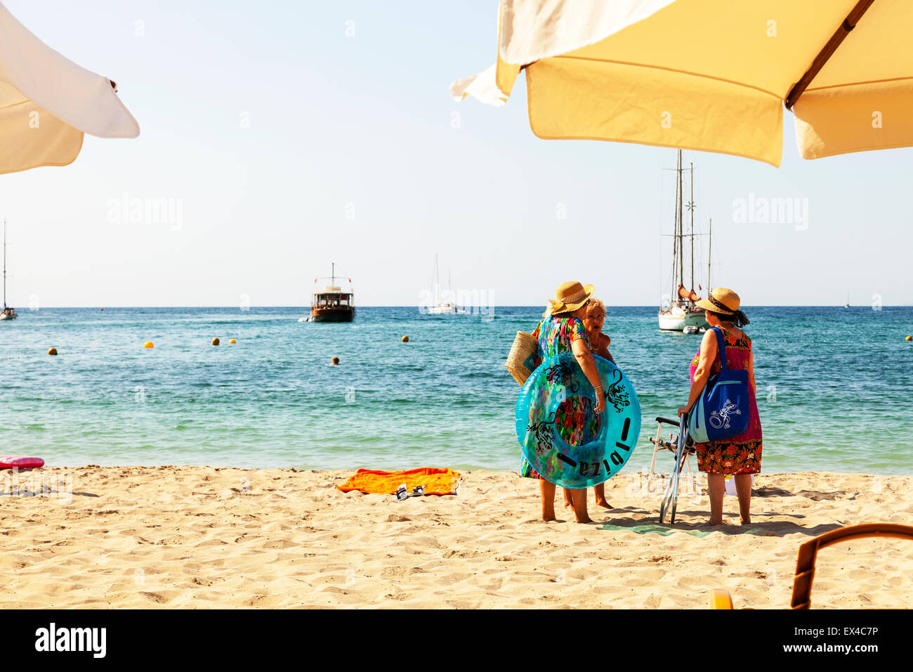 Old women on beach talking gossiping gossip chat chatting inflatable ...