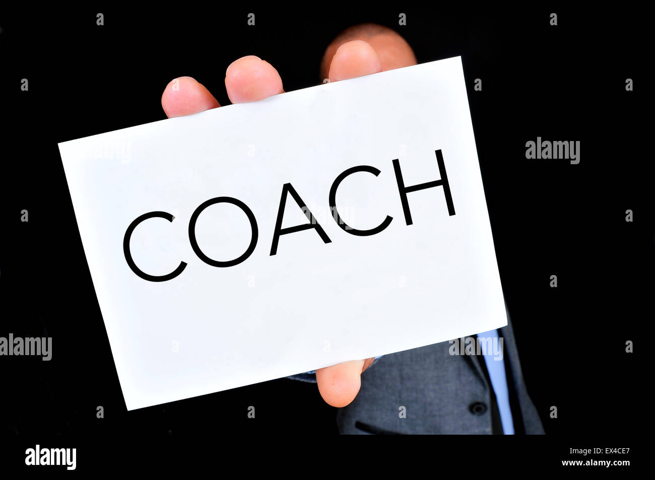 a young caucasian man wearing a gray suit and a blue shirt shows a ...