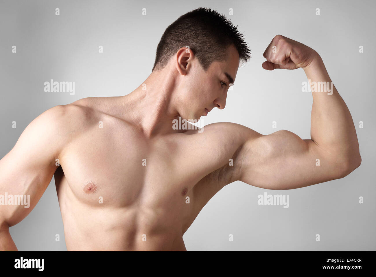 man flexing biceps muscles Stock Photo - Alamy
