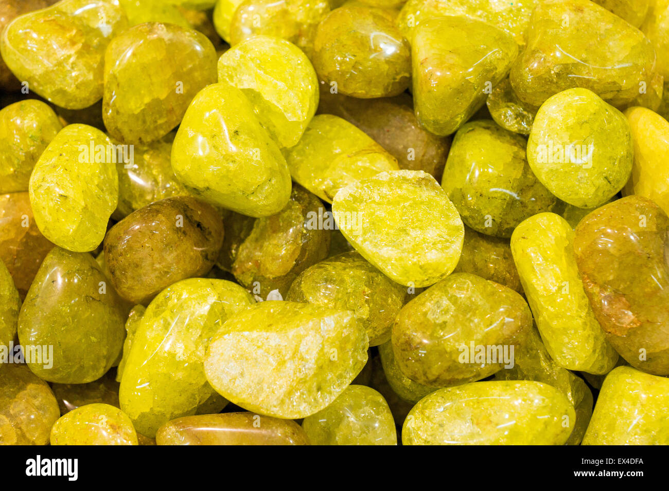 A background of some yellow semiprecious pebbles Stock Photo - Alamy