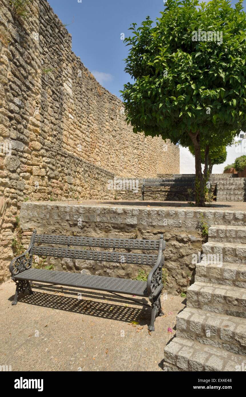 Iron bench on stone street in the villlage of Medina Sidonia, a white ...