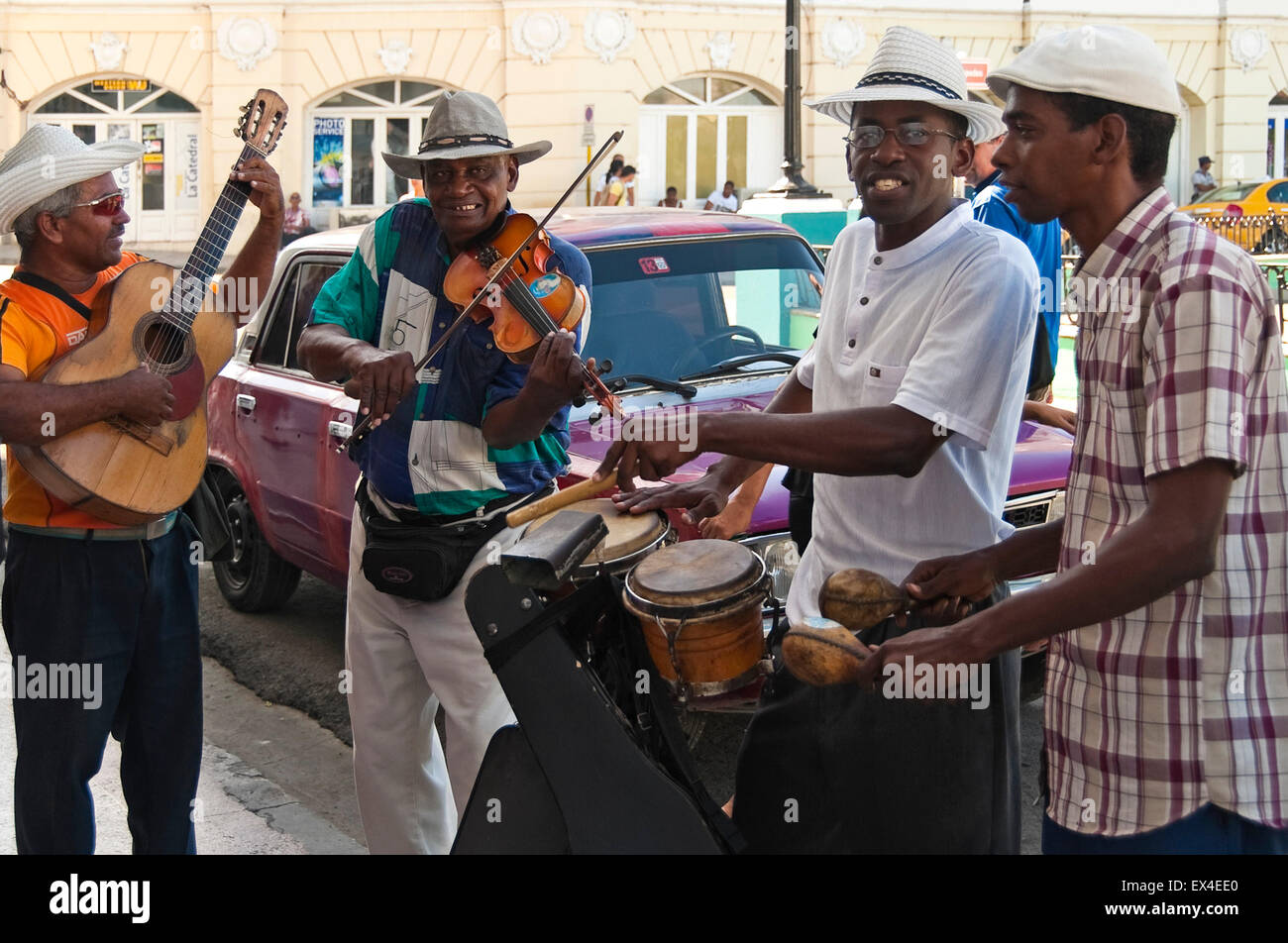Horizontal view of a typical salsa group busking on the streets of ...