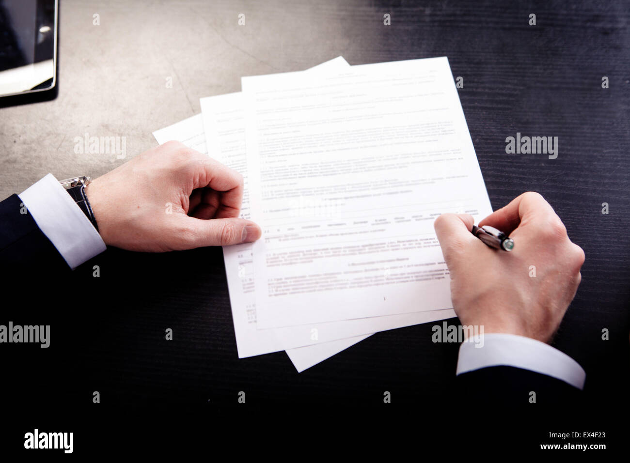 Image of human hand with pen over documents at workplace Stock Photo ...