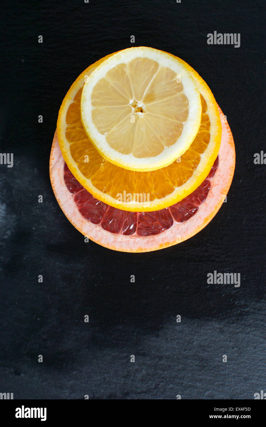 Slices of citrus on a slate platter Stock Photo - Alamy
