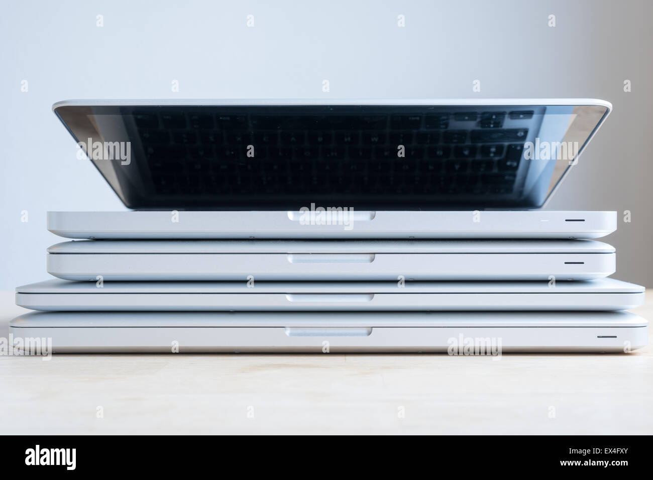 A bunch of aluminum laptops stacked on top of each other. The one on ...