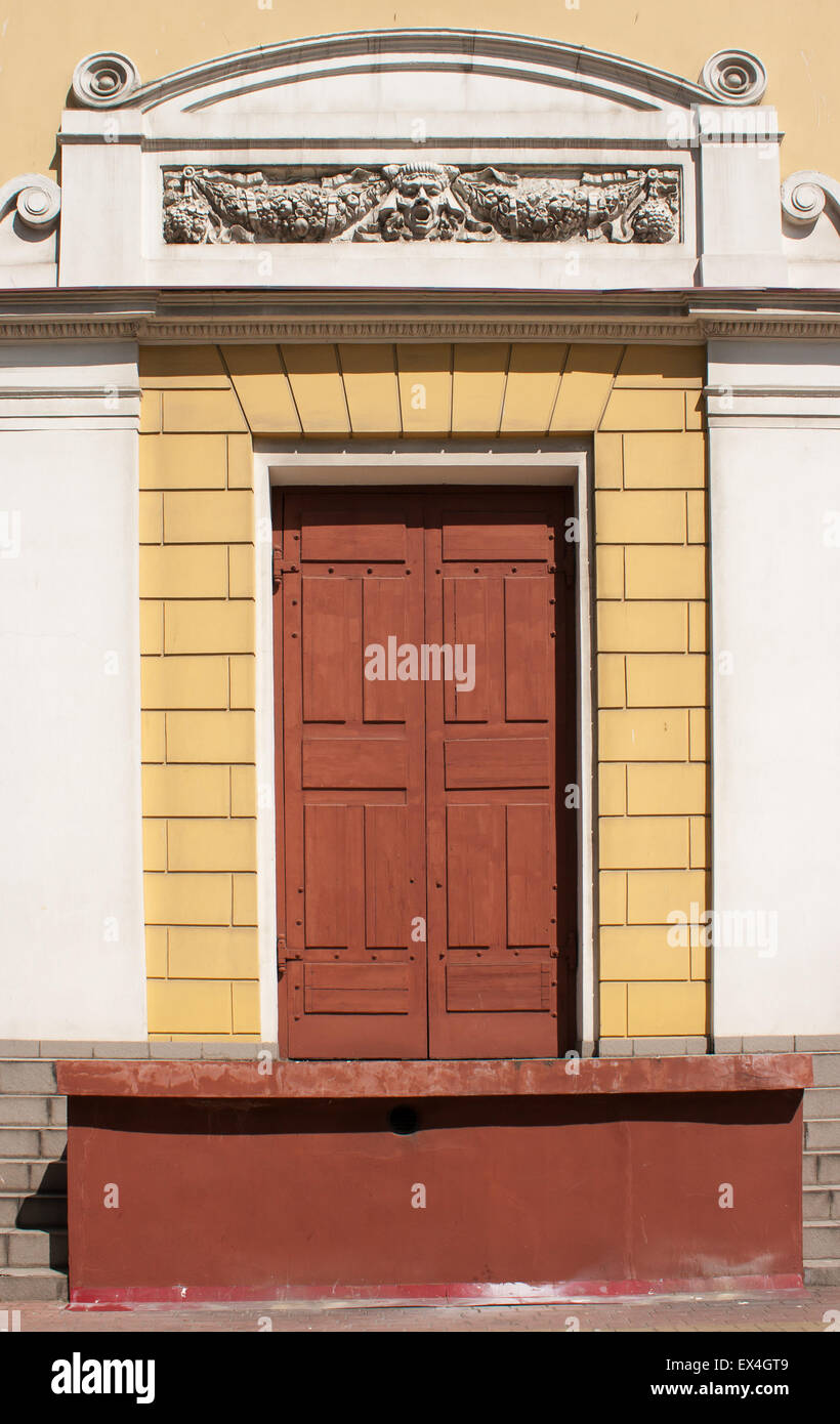 retro front door decorated with bas-reliefs on sunny day, detail Stock ...