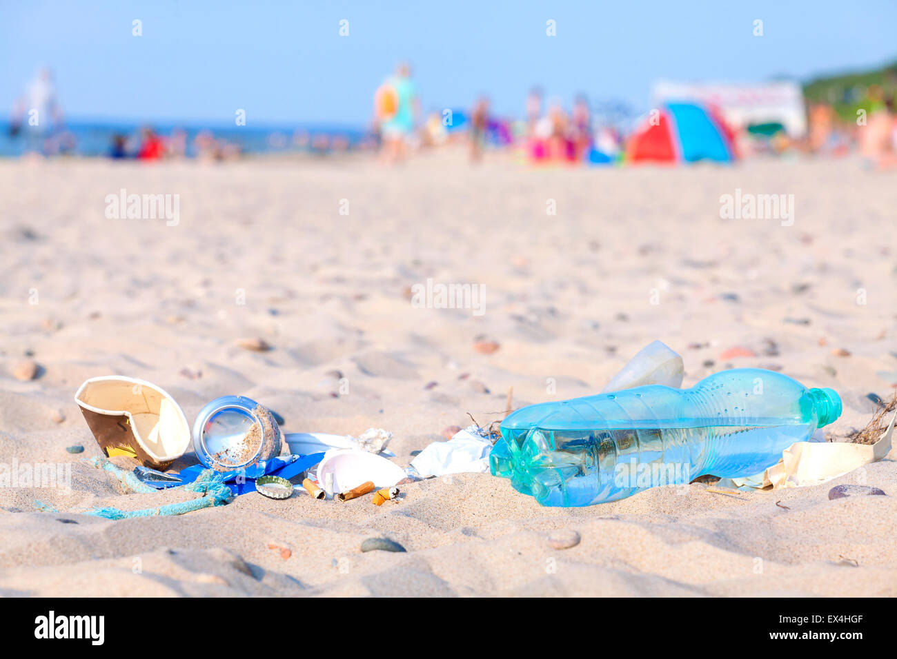 Garbage on a beach left by tourist at sunset, environmental pollution ...