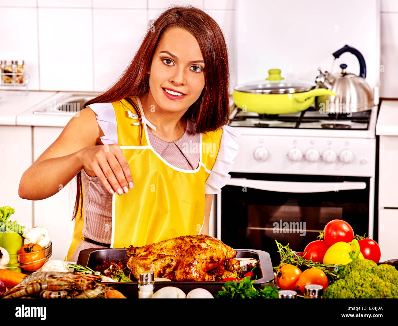 Woman cooking chicken at kitchen Stock Photo - Alamy