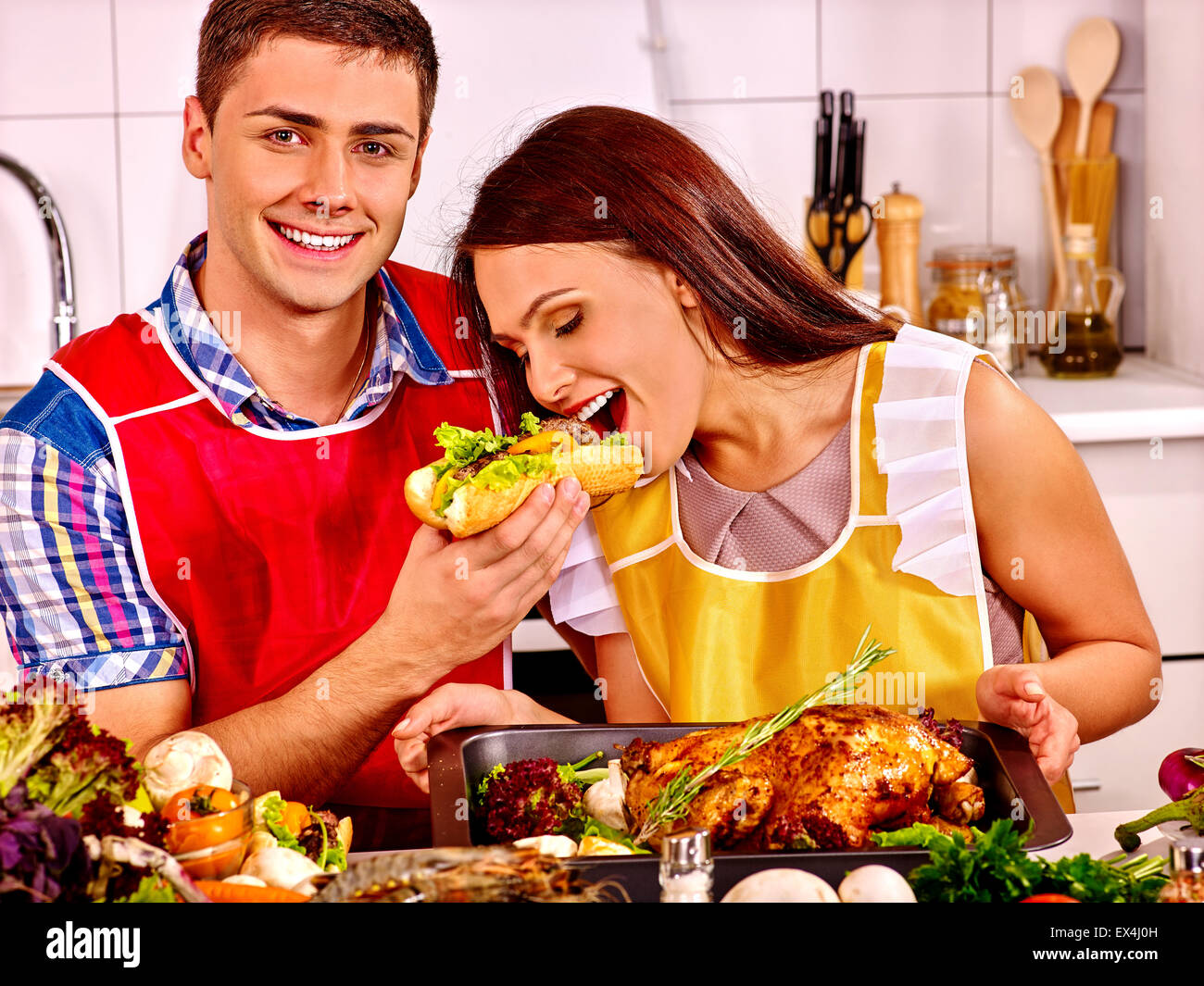 Couple cooking chicken at kitchen Stock Photo - Alamy