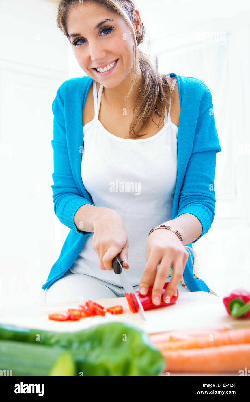 Portrait of Pretty young woman cooking at home Stock Photo - Alamy