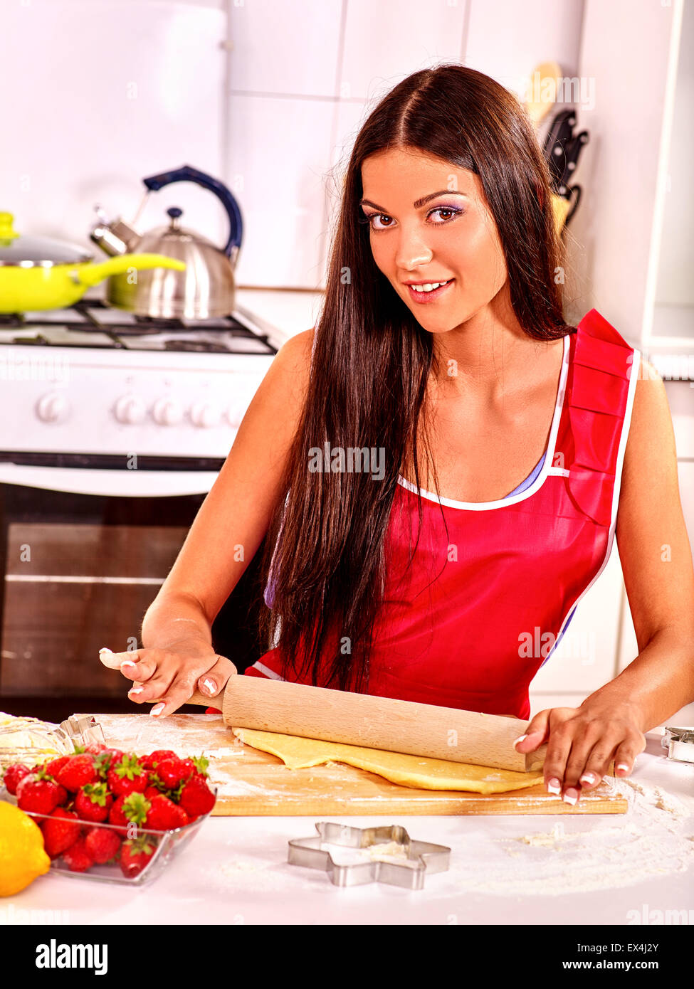 Young woman cooking at kitchen Stock Photo - Alamy