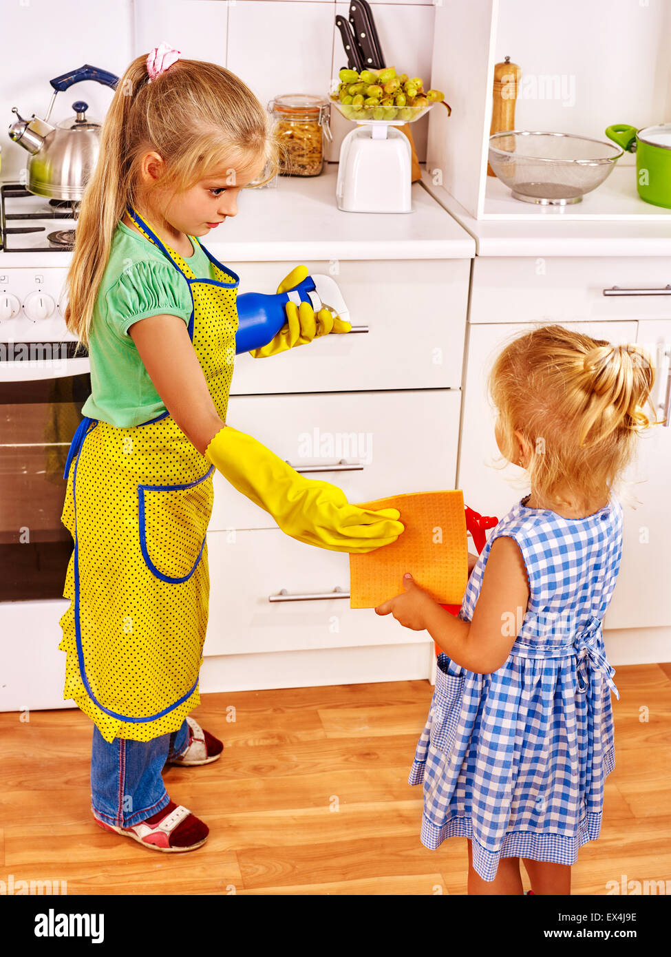 Children cleaning kitchen Stock Photo - Alamy