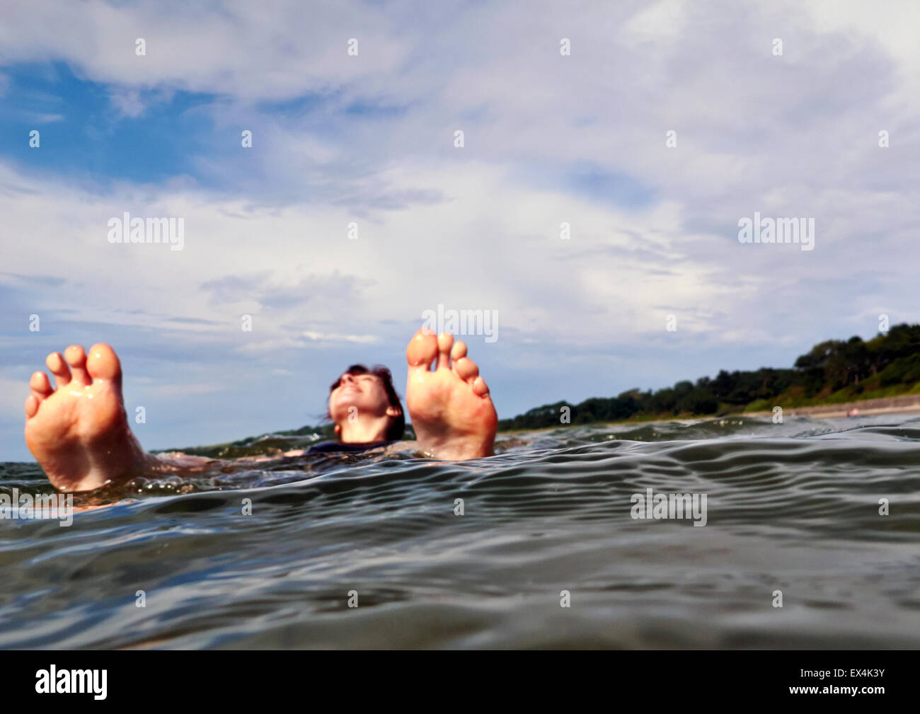a person floating in the irish sea Stock Photo - Alamy