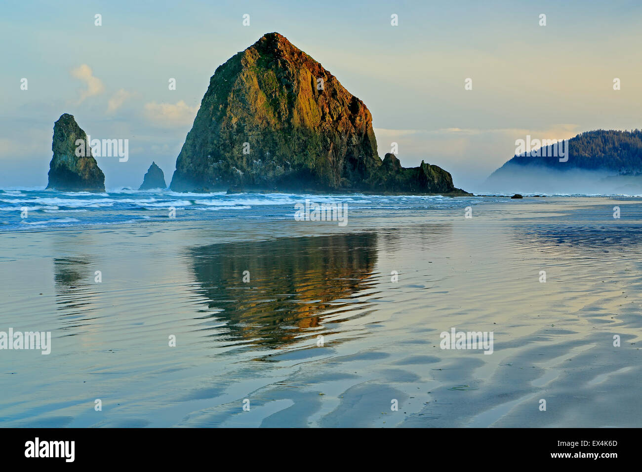 Haystack Rock reflected on water and ripples, Cannon Beach, Oregon USA ...